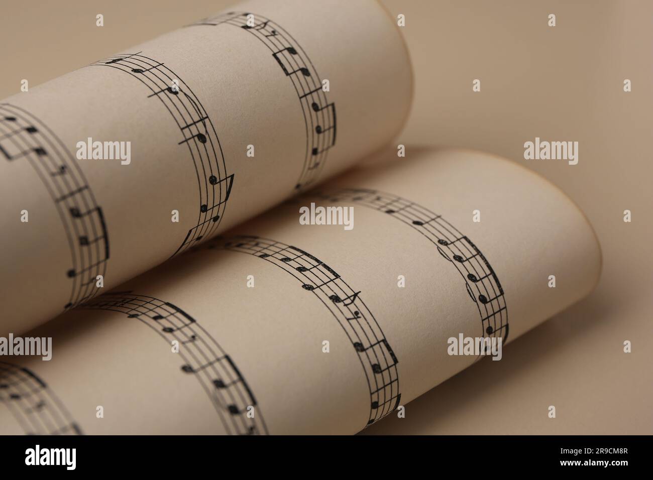 Rolled sheets with music notes on light background, closeup Stock Photo ...
