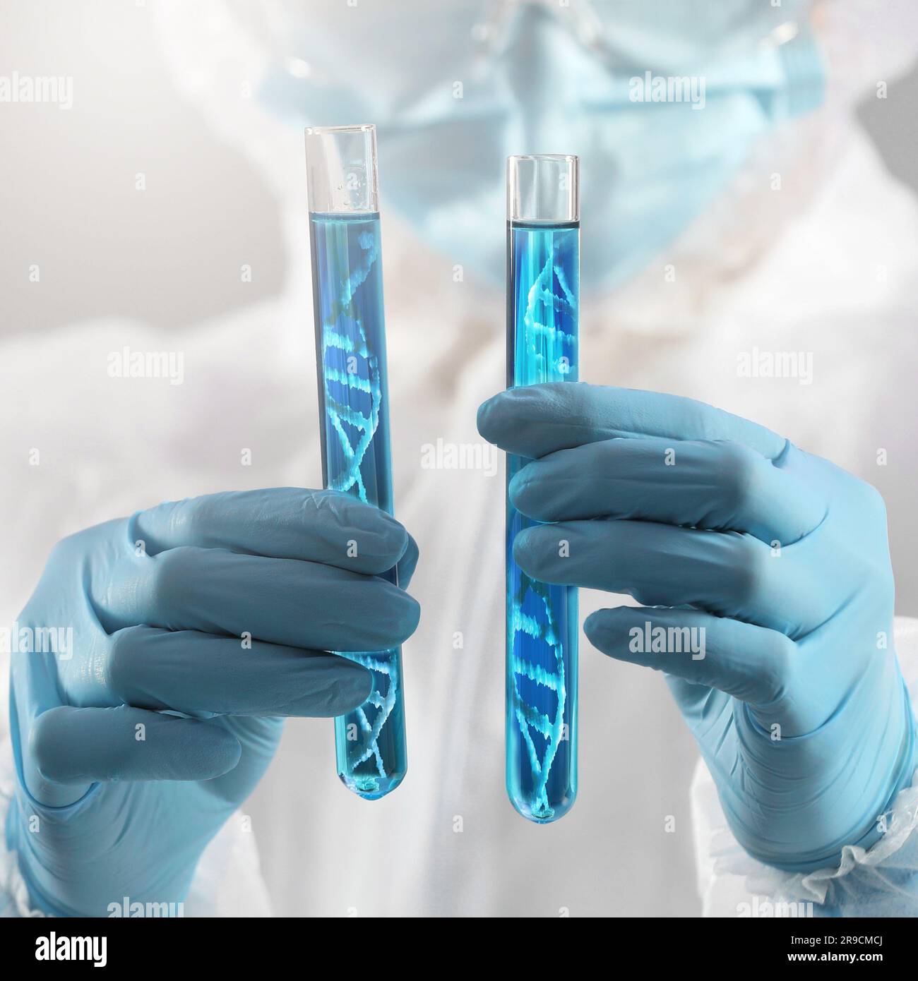 Genetics research. Scientist holding test tubes with liquid and ...