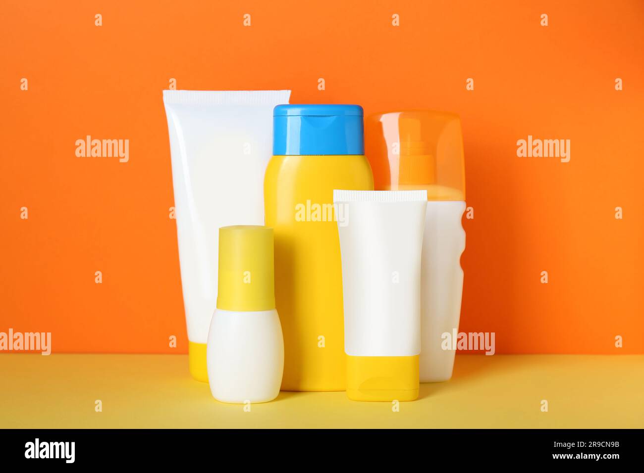 Set of different suntan products on color background Stock Photo - Alamy