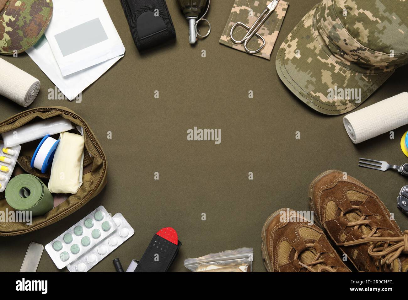 Flat lay composition with first aid kit and military uniform on khaki ...