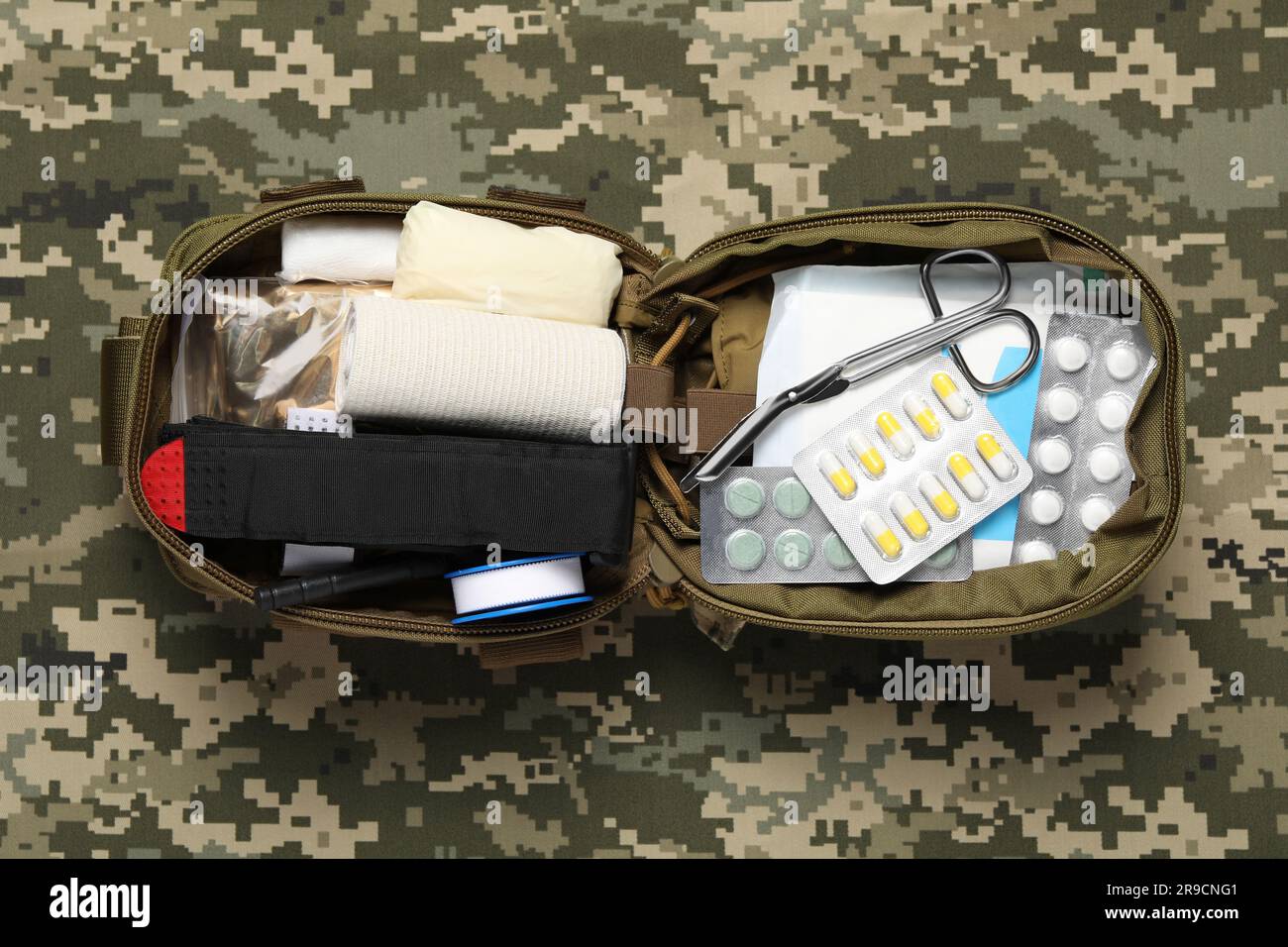 Military first aid kit on camouflage fabric, top view Stock Photo - Alamy