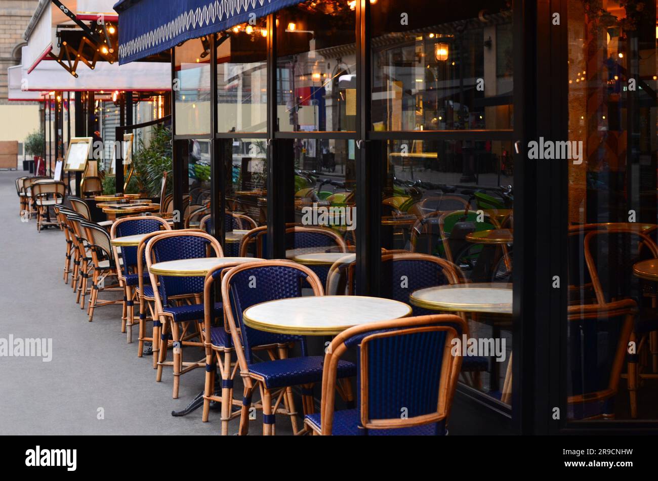 Outdoor cafe with rattan chairs and tables Stock Photo - Alamy