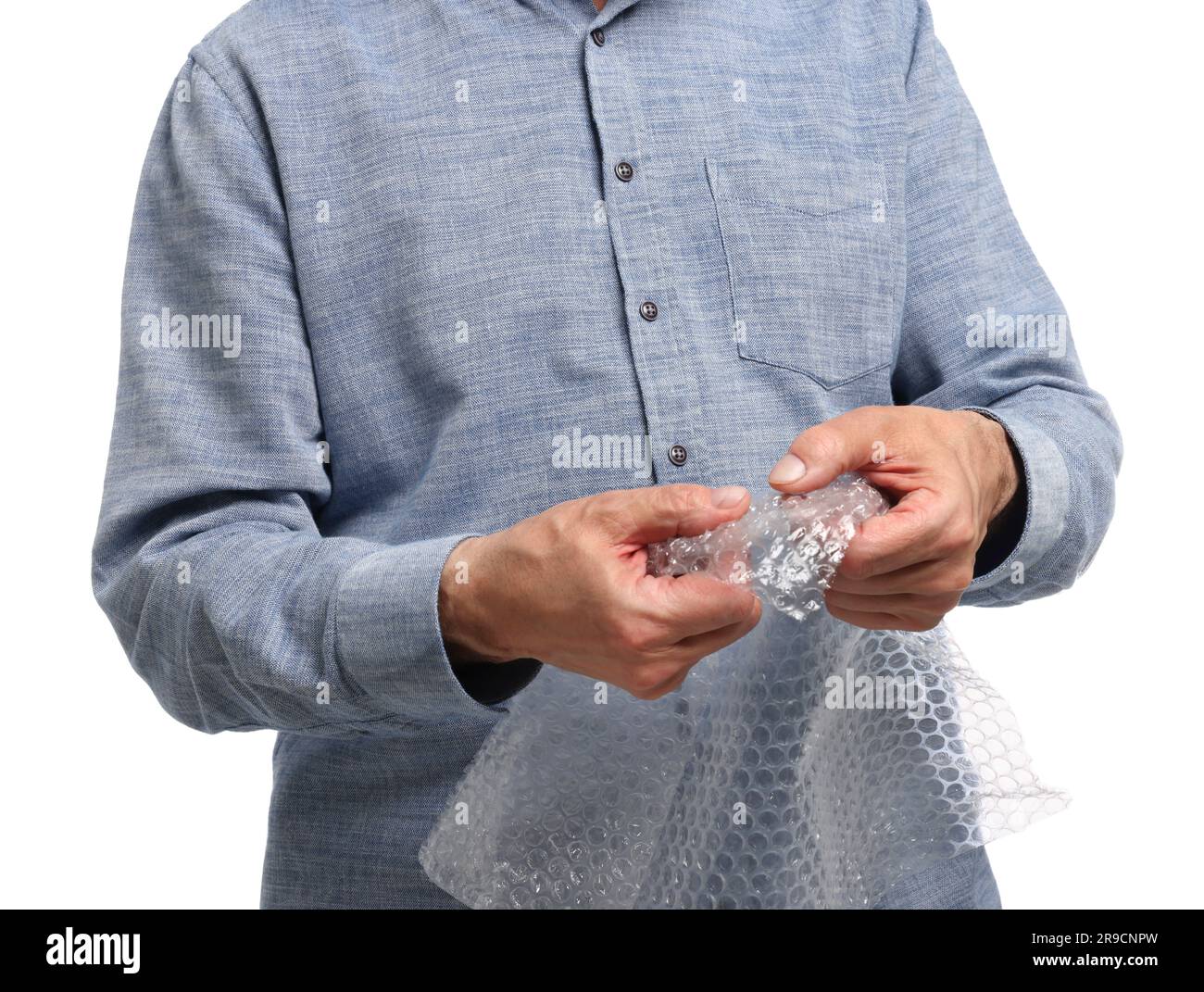 Senior man popping bubble wrap on white background, closeup. Stress ...