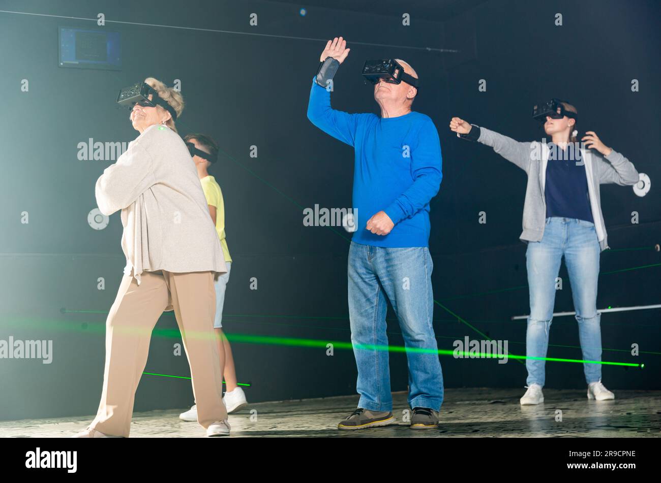 Family are wearing virtual reality goggles in the quest room Stock ...
