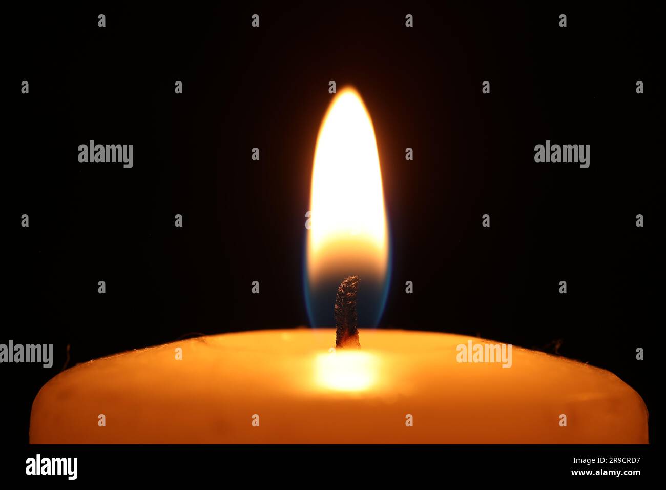 Burning wax candle on black background, closeup Stock Photo - Alamy