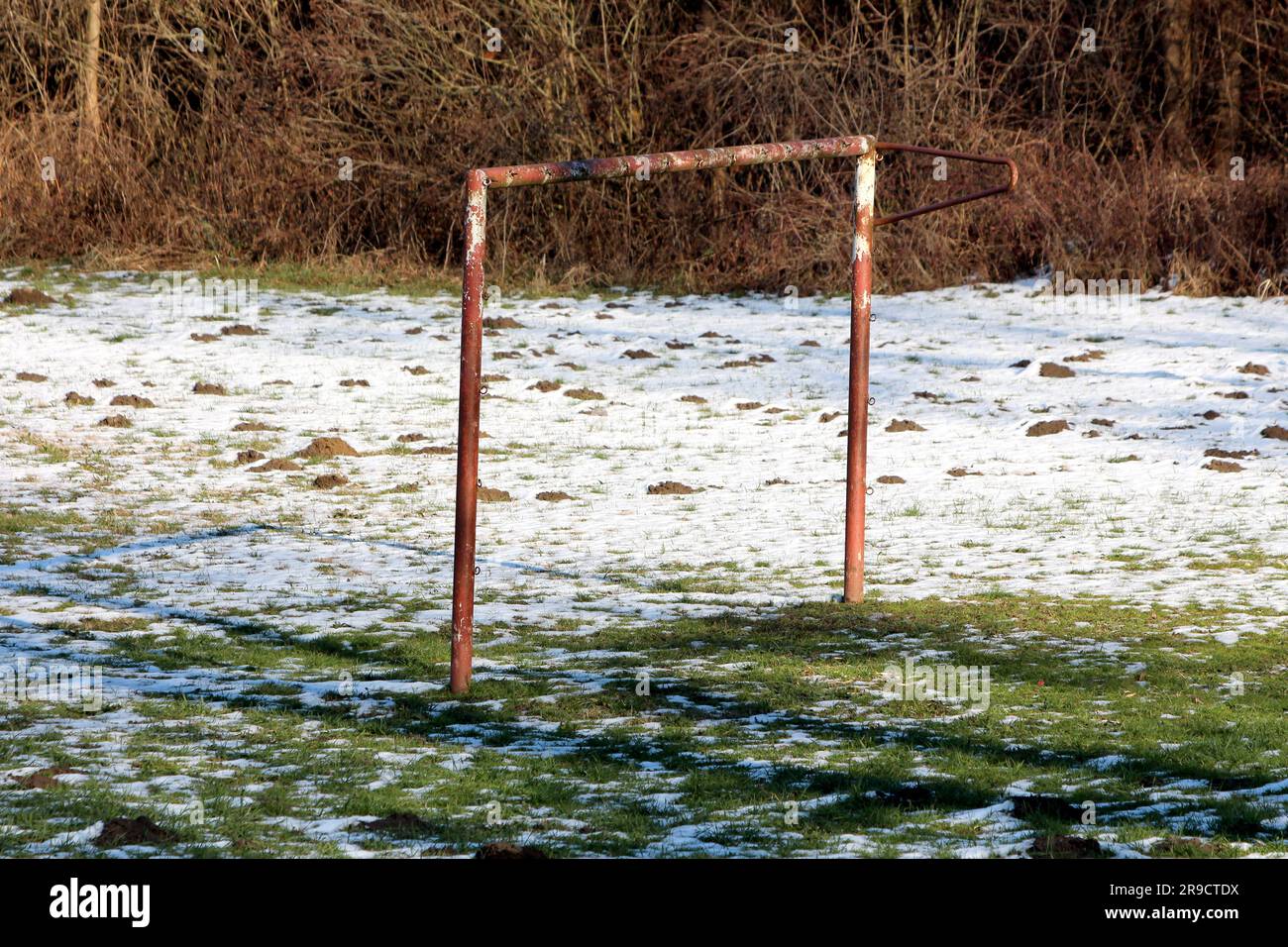 Rusted old goal post without net left on abandoned children playground ...