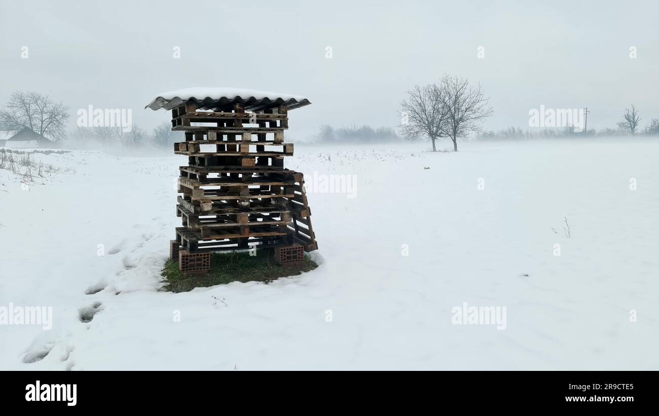 Stack of old used wooden pallets on top of four red building blocks ...