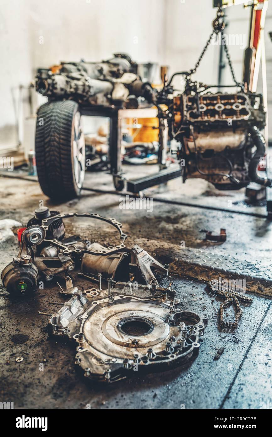disassemble the engine from the car in the car workshop Stock Photo - Alamy