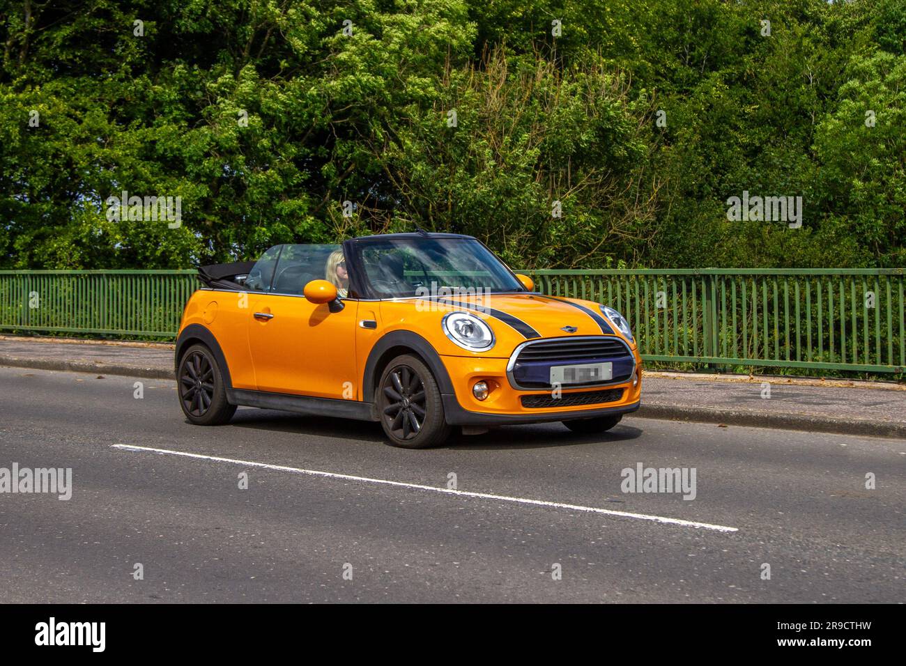 2016 Orange Mini Cooper travelling at speed on the M6 motorway in ...