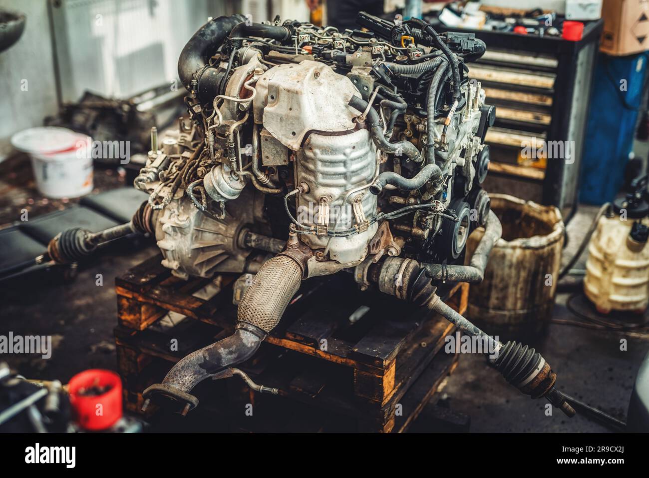 disassemble the engine from the car in the car workshop Stock Photo - Alamy