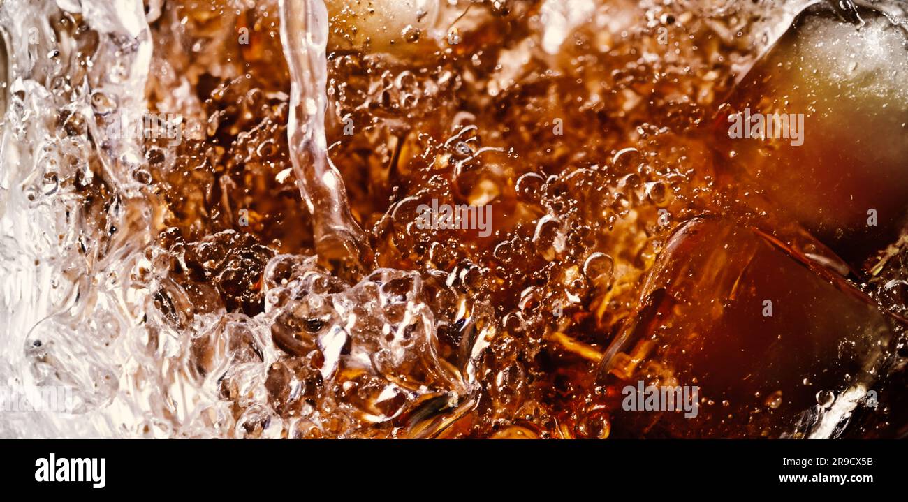 Splashing of Cola and Ice. Cola soda and ice splashing fizzing or ...