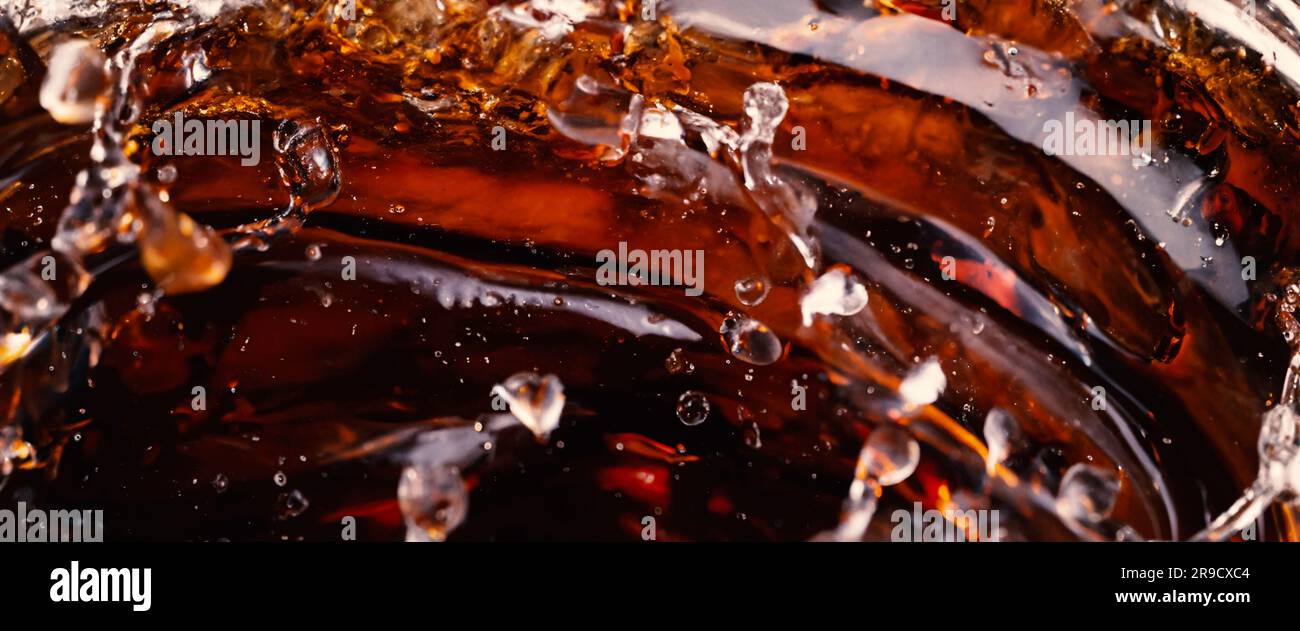 Splashing of Cola and Ice. Cola soda and ice splashing fizzing or ...