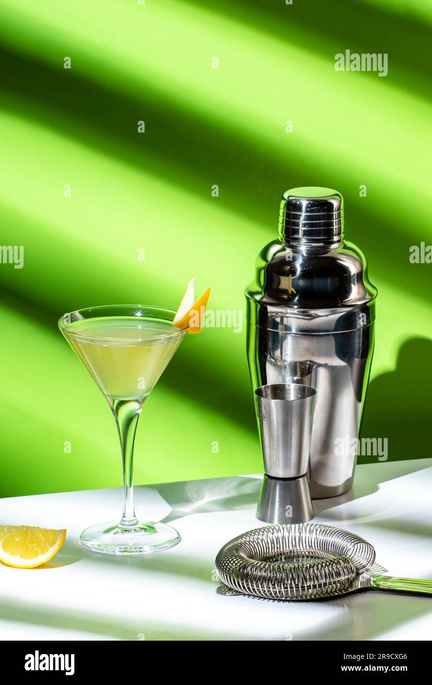 Vesper cocktail drink with dry gin, vodka, aperitif, lemon zest and ice ...