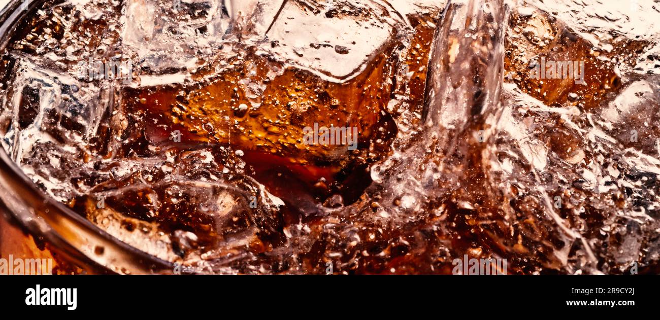 Splashing of Cola and Ice. Cola soda and ice splashing fizzing or ...