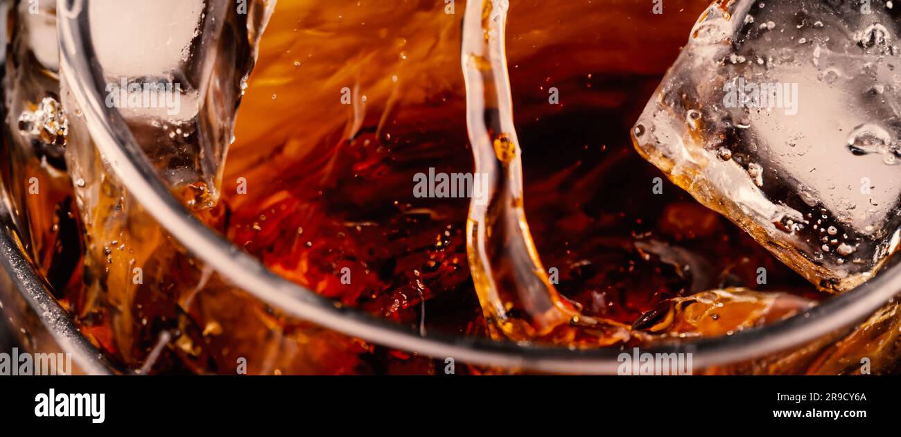 Splashing of Cola and Ice. Cola soda and ice splashing fizzing or ...