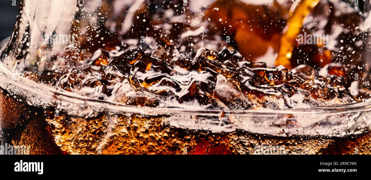 Splashing of Cola and Ice. Cola soda and ice splashing fizzing or ...