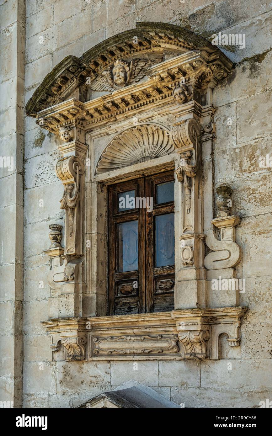 window decorated in Baroque style on the facade of the church of the ...