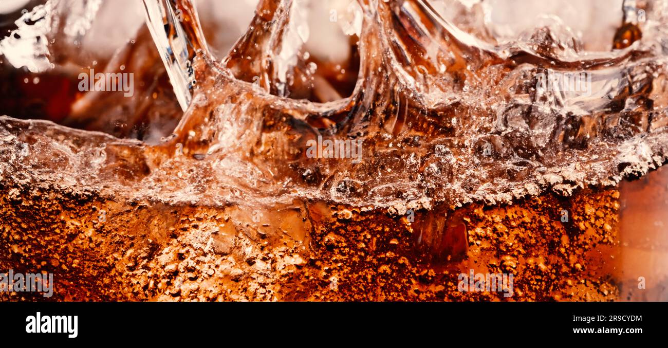 Splashing of Cola and Ice. Cola soda and ice splashing fizzing or floating up to top of surface ...