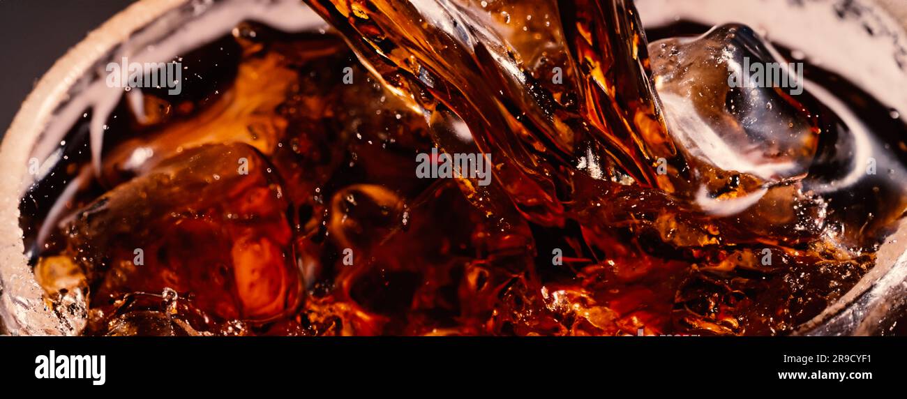 Splashing of Cola and Ice. Cola soda and ice splashing fizzing or ...