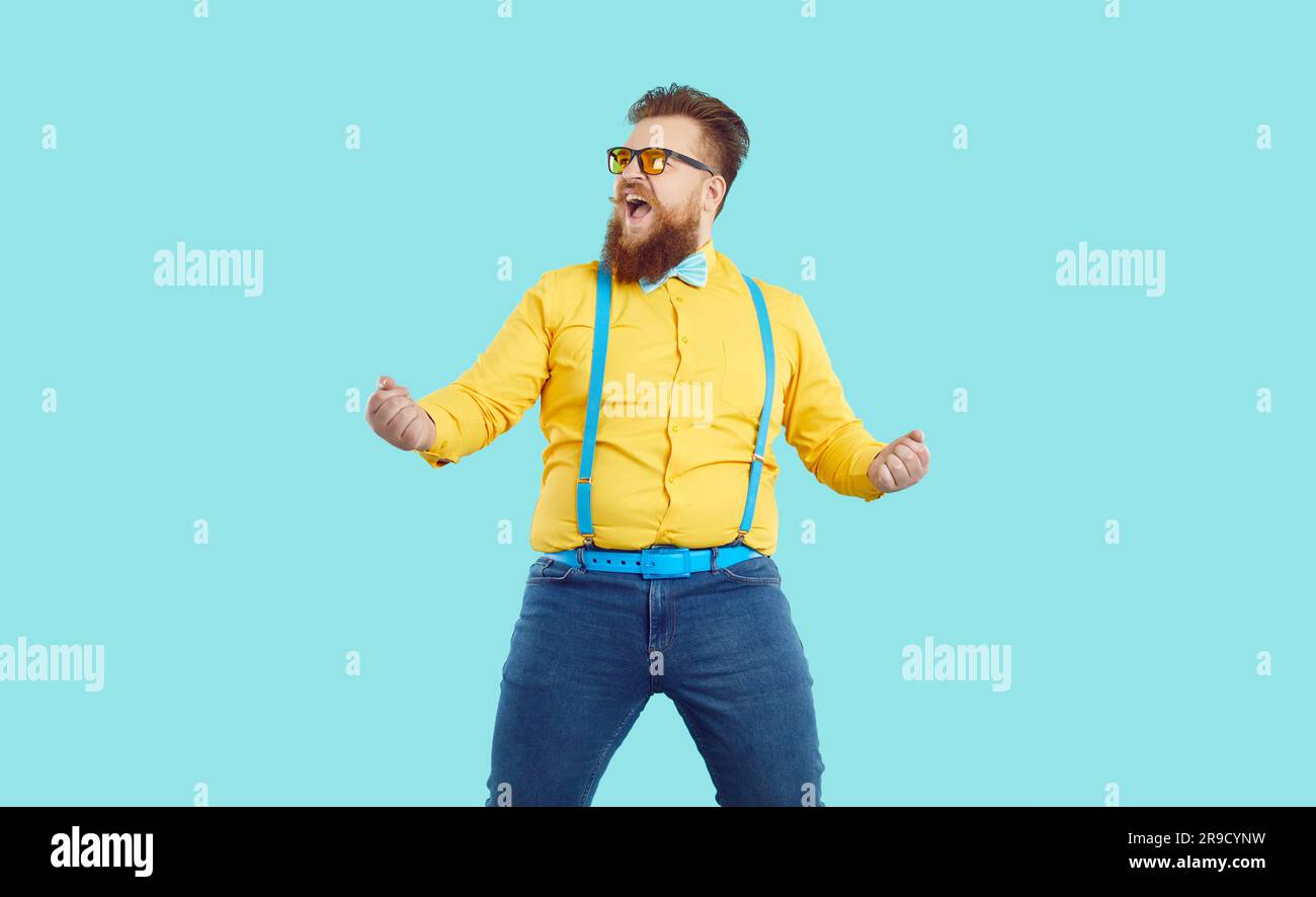 Happy funny excited crazy chubby young guy celebrating, shouting YES ...
