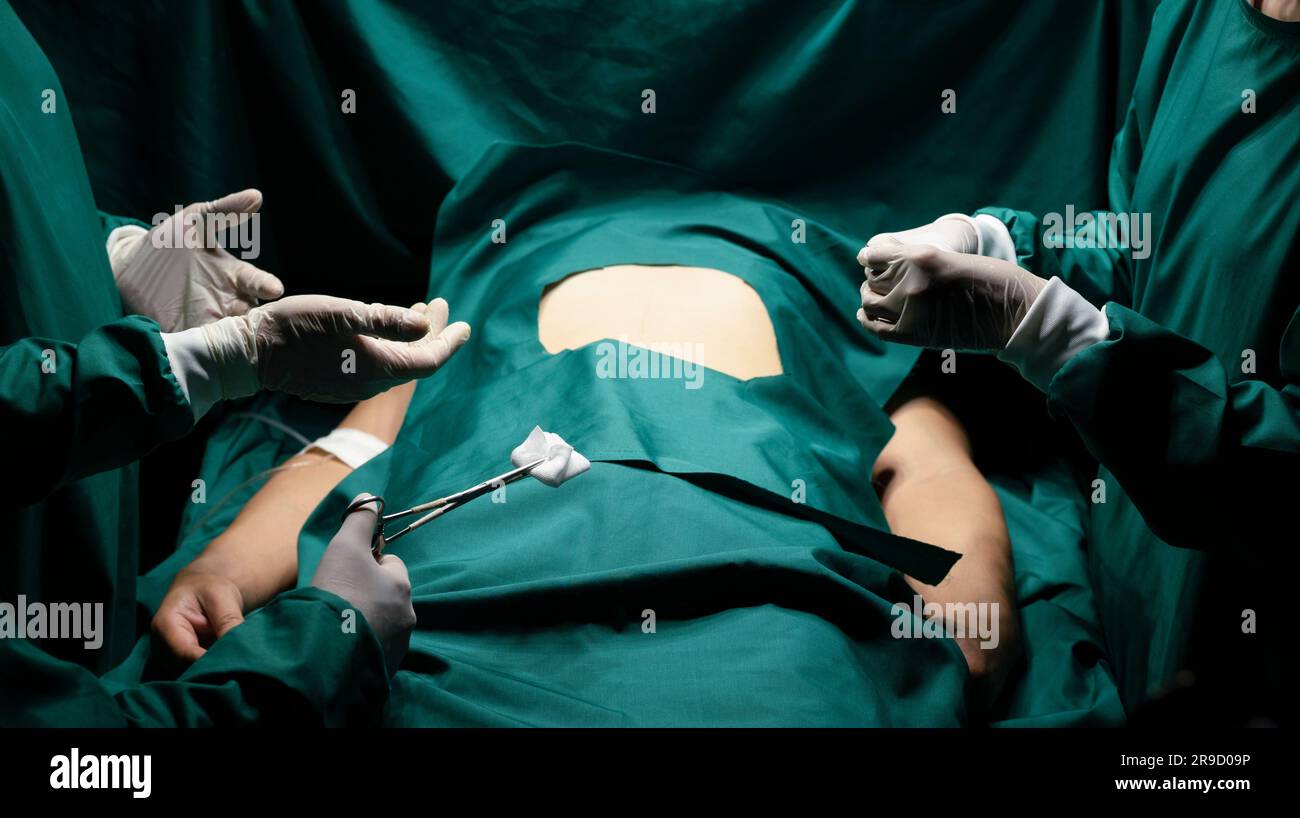 A team of medical professionals operating on a patient Stock Photo - Alamy