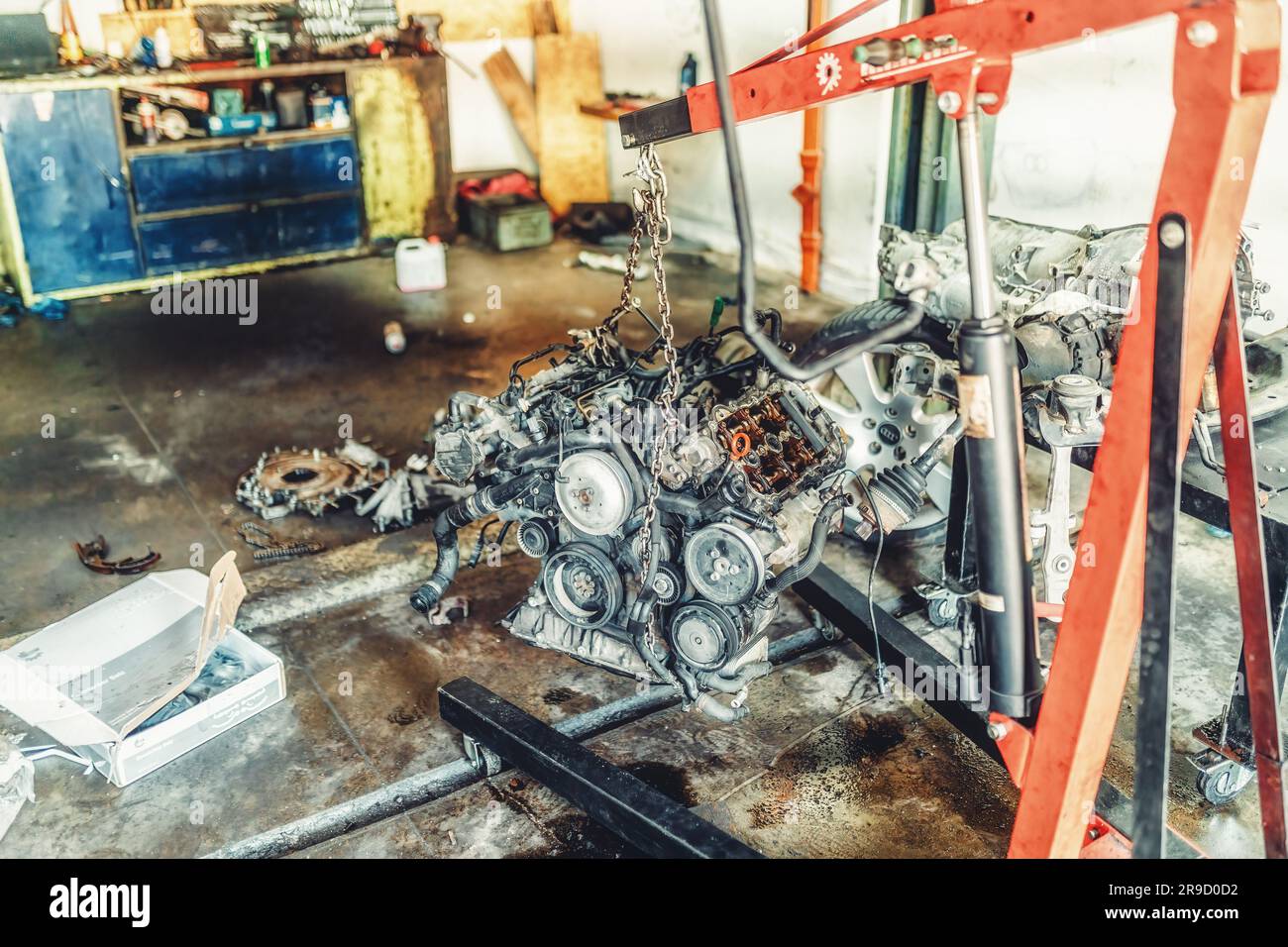 disassemble the engine from the car in the car workshop Stock Photo - Alamy