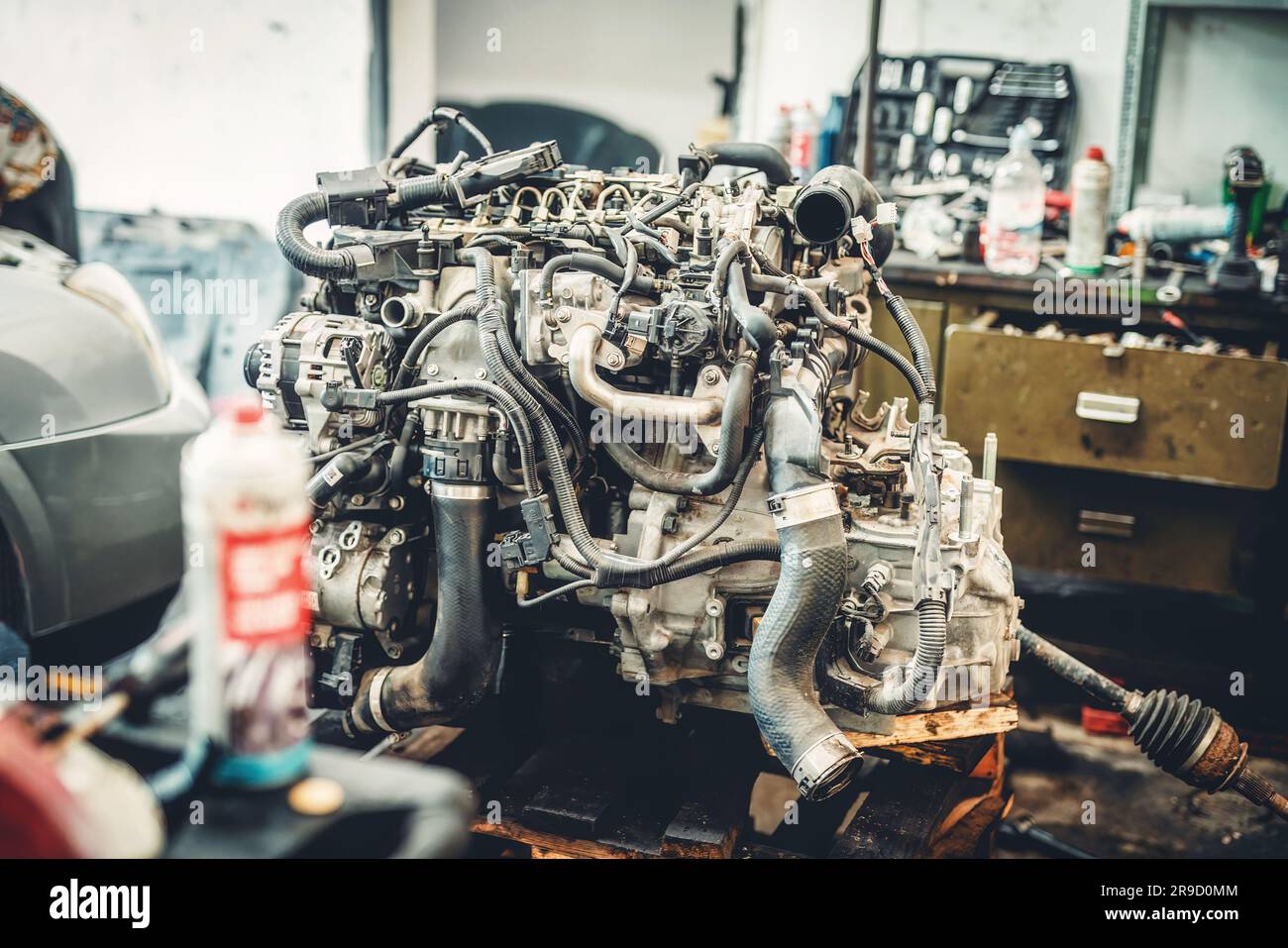 disassemble the engine from the car in the car workshop Stock Photo - Alamy