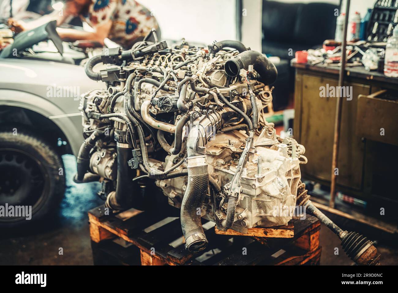 disassemble the engine from the car in the car workshop Stock Photo - Alamy