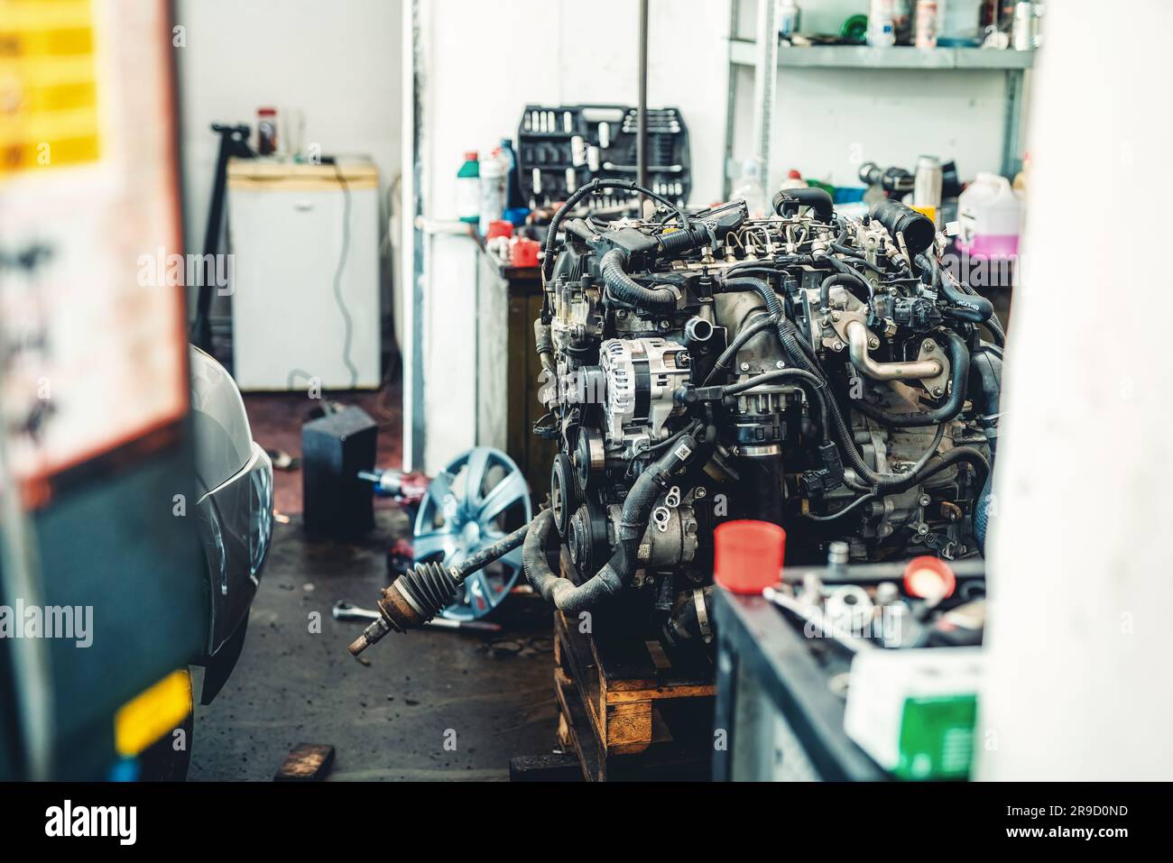 disassemble the engine from the car in the car workshop Stock Photo - Alamy