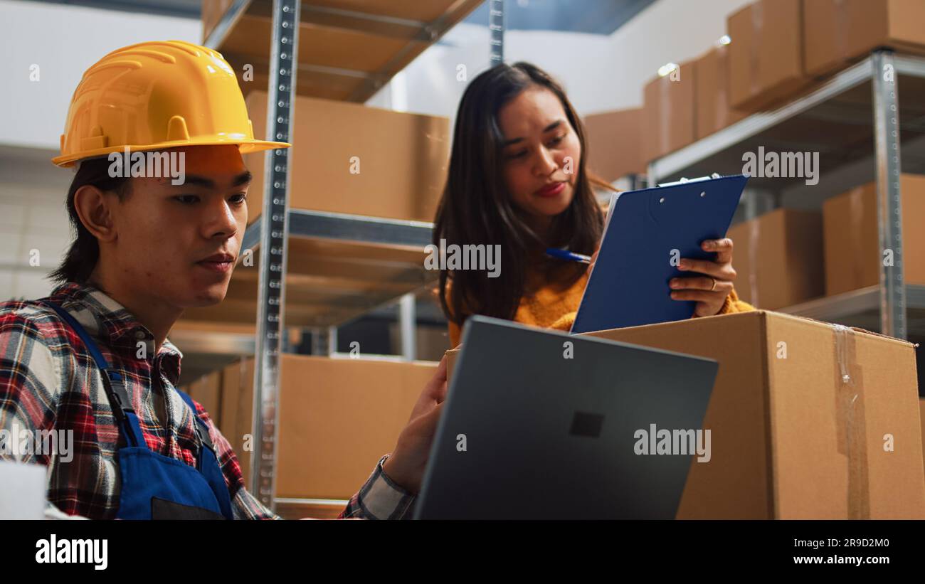 Young person planning distribution of orders in depot, working with ...