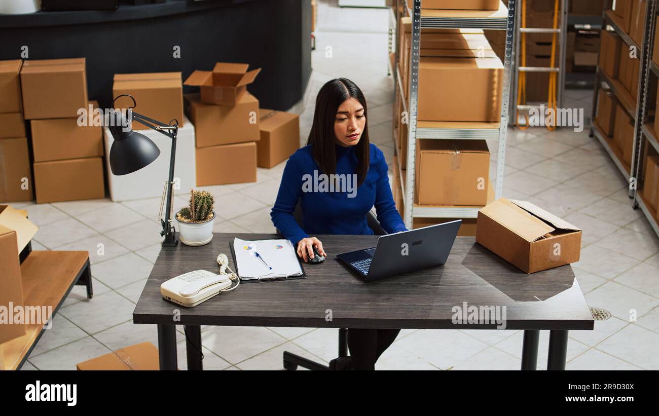 Small business owner planning distribution with goods, checking ...