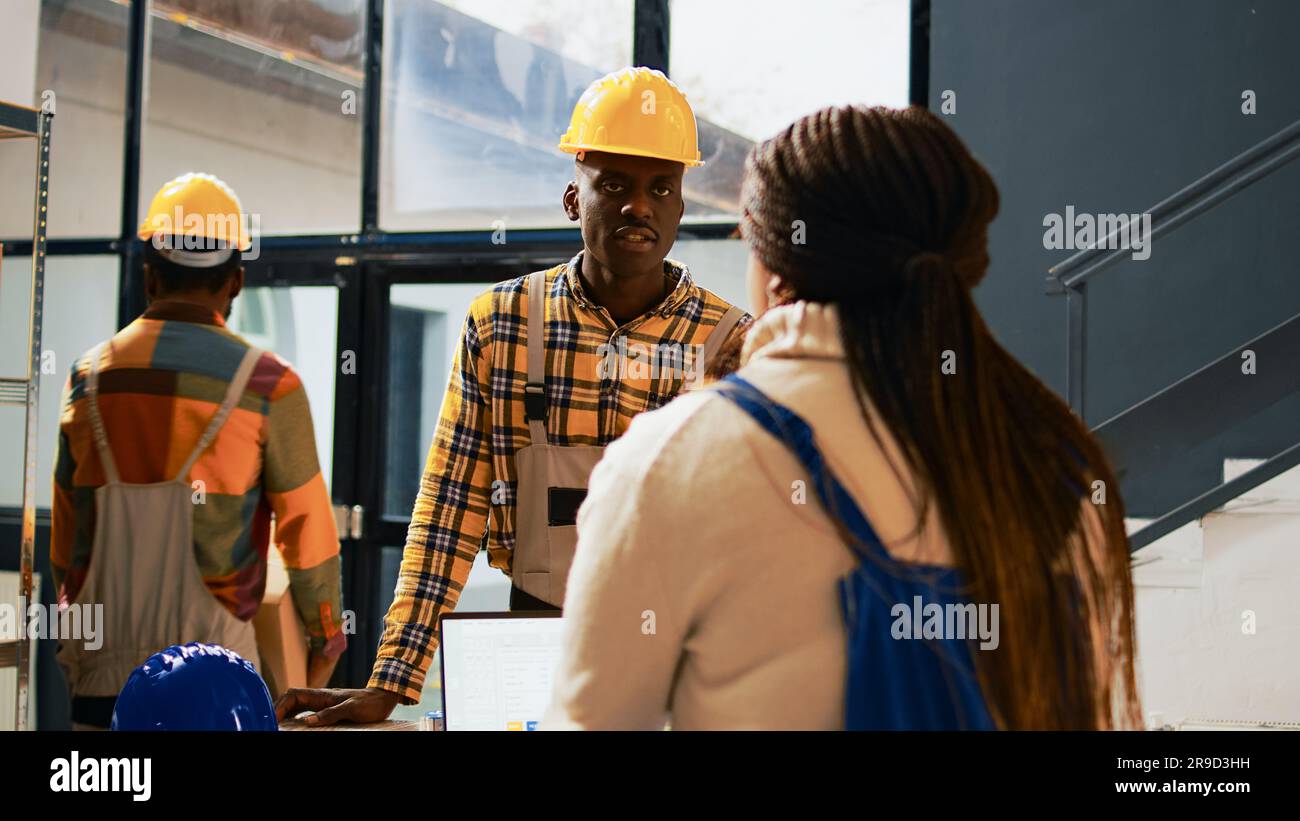 Happy employees having fun in storage room, working on manufacturing ...