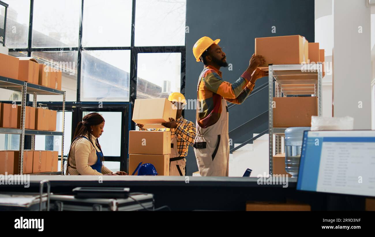 Team warehouse employees taking boxes hi-res stock photography and ...
