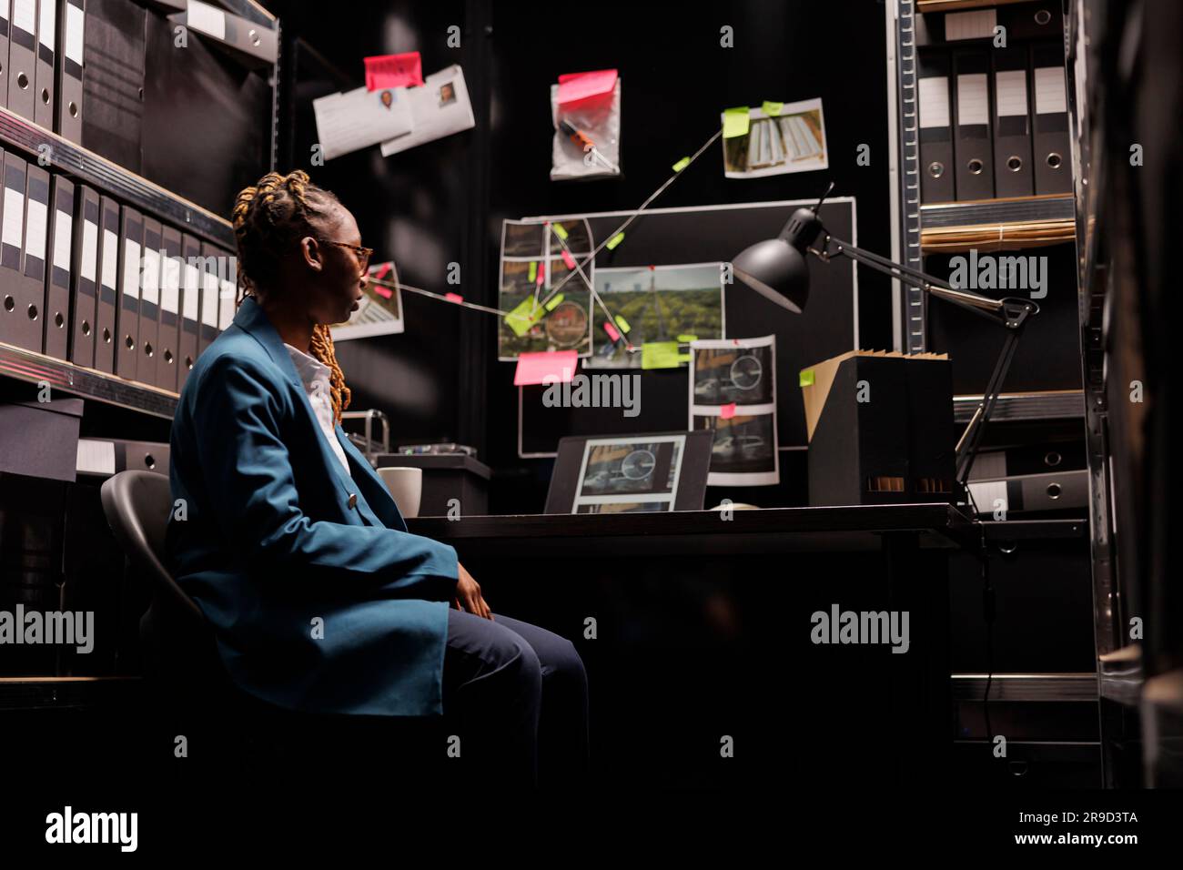 Woman detective assistant analyzing clues, working on crime solving in ...