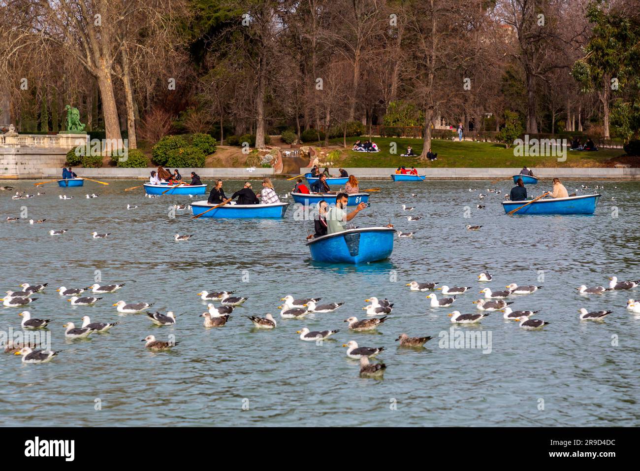 Madrid, Spain - FEB 16, 2022: People having fun on rowing boats on the ...