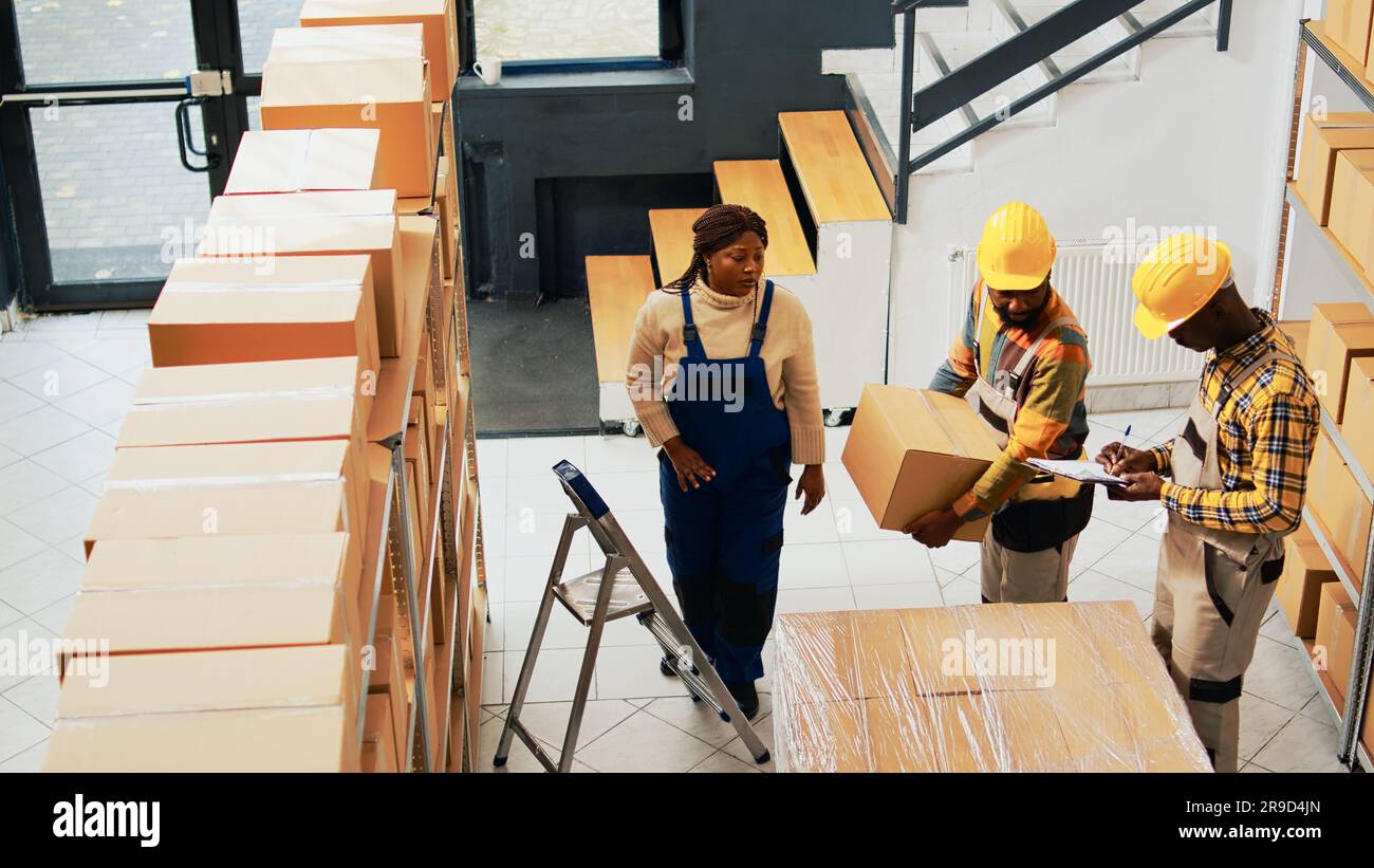 African american people organizing products in boxes, putting packages ...