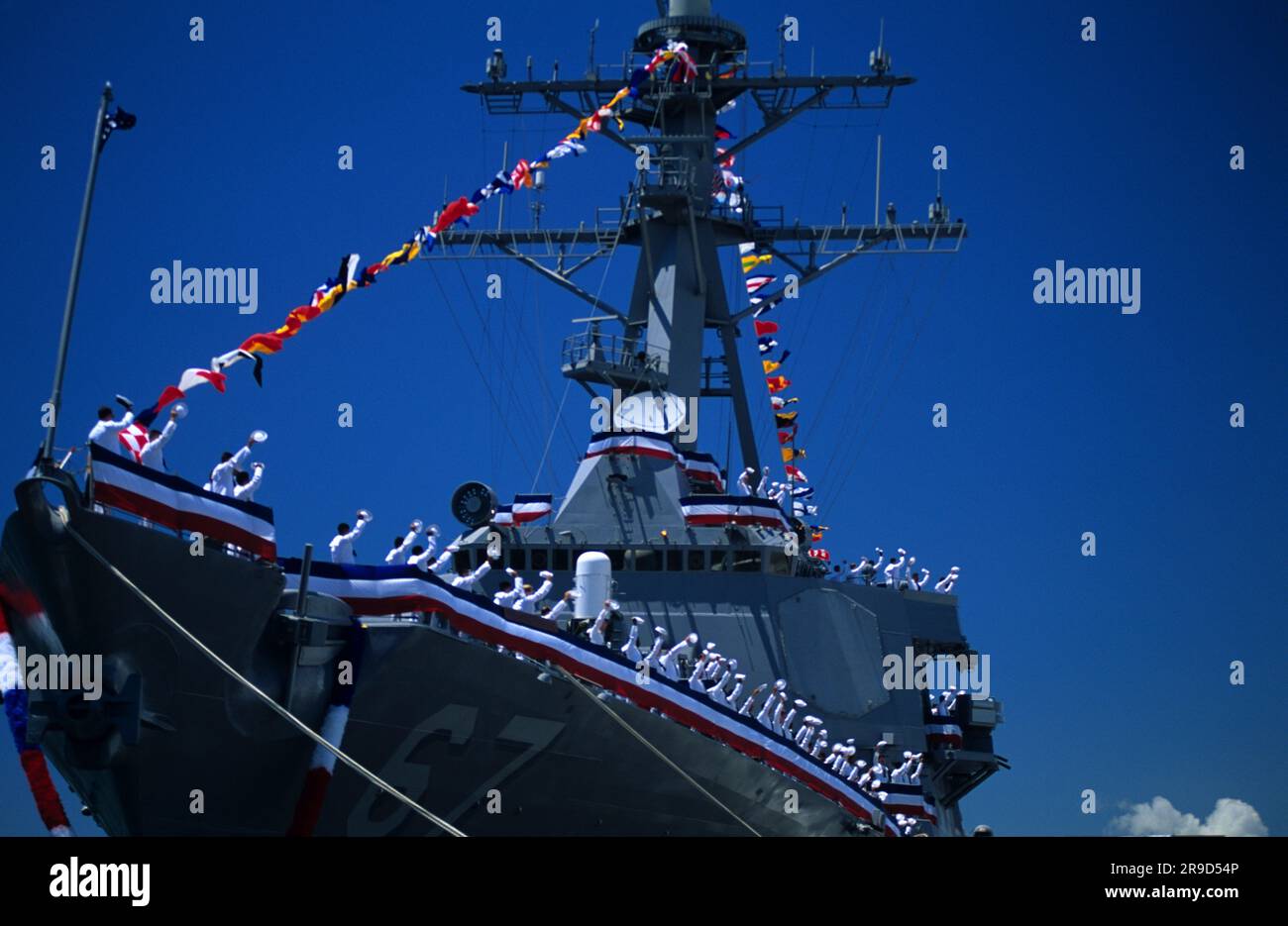 Sailors with hats off during the commissioning of the destroyer, the ...