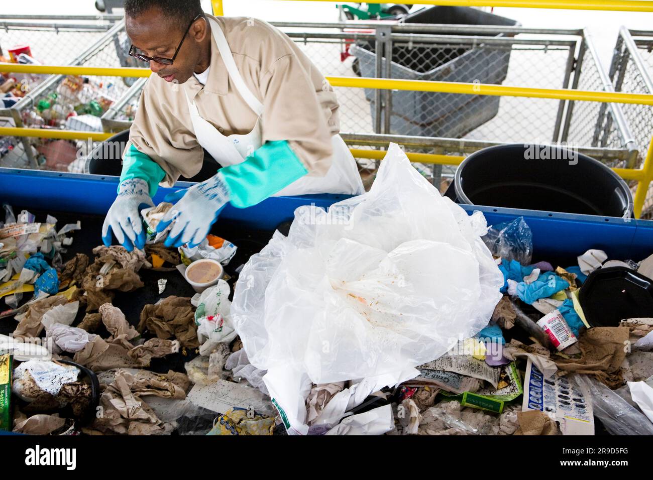 An inmate removes recyclables from the waste stream Stock Photo - Alamy