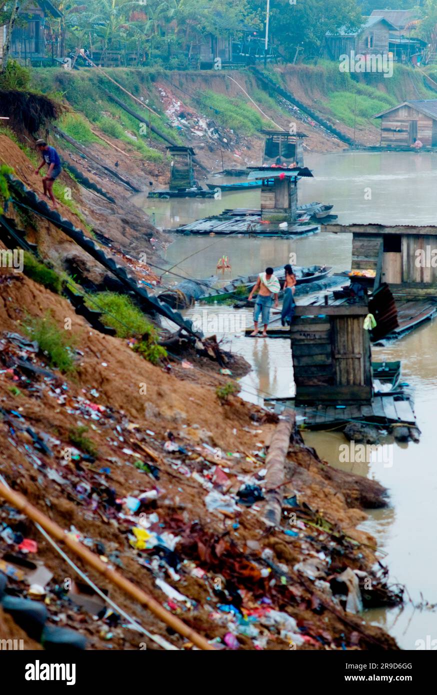 At dawn and dusk villagers bath, wash cloths and dishes in the river ...