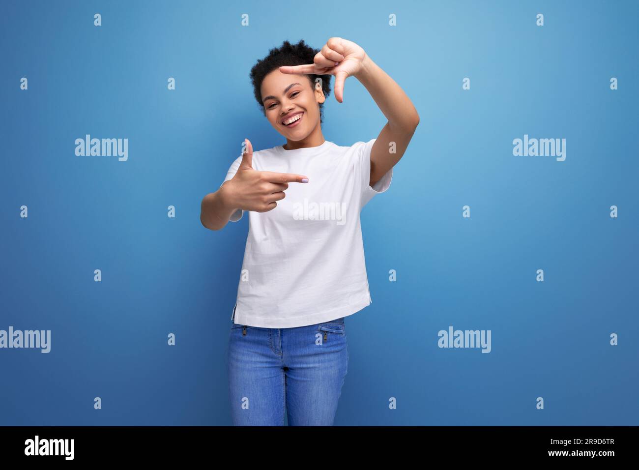beautiful young swarthy woman with fluffy curly hair, dressed in a ...