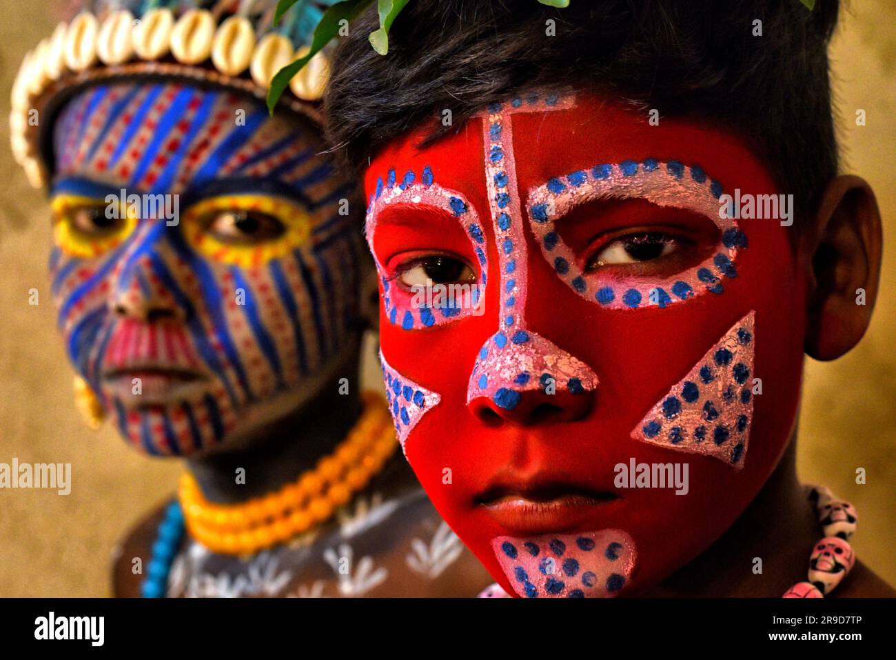 Two children pose with their faces painted as part of their ...