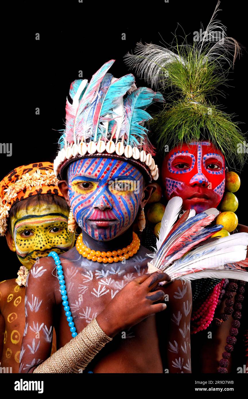 Young children pose with their faces painted as part of their ...