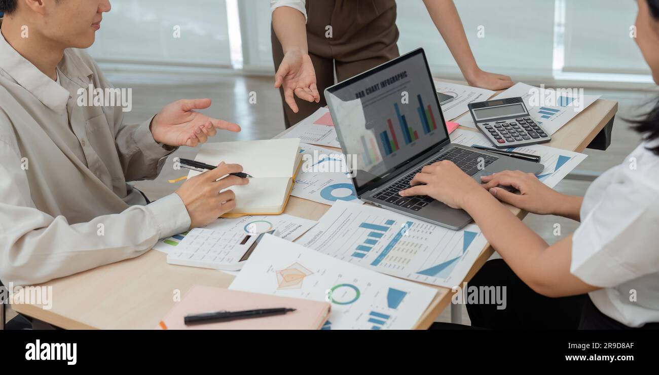 Business team using a calculator to calculate the numbers of statistic ...