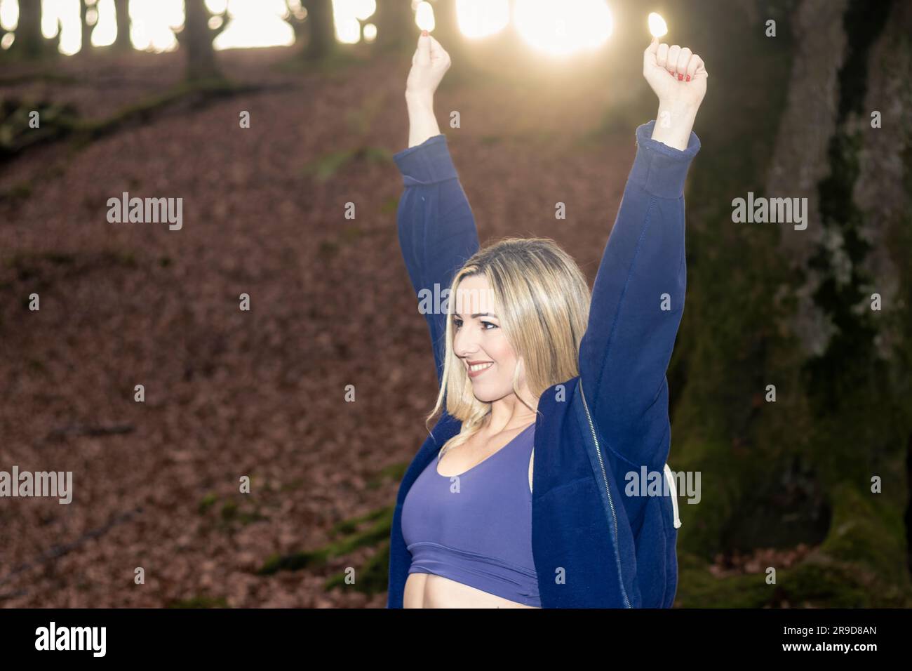 Blonde Woman Embracing the Joy of Nature with Arms Raised in a Mountain ...