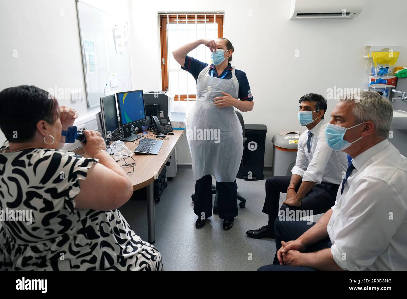 Britain's Prime Minister Rishi Sunak, second rightwith Health Secretary ...