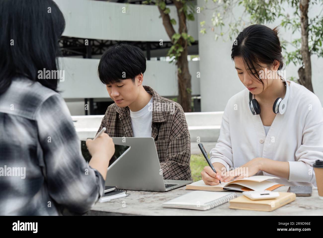 Group of happy students checking results on laptop and tablet while ...