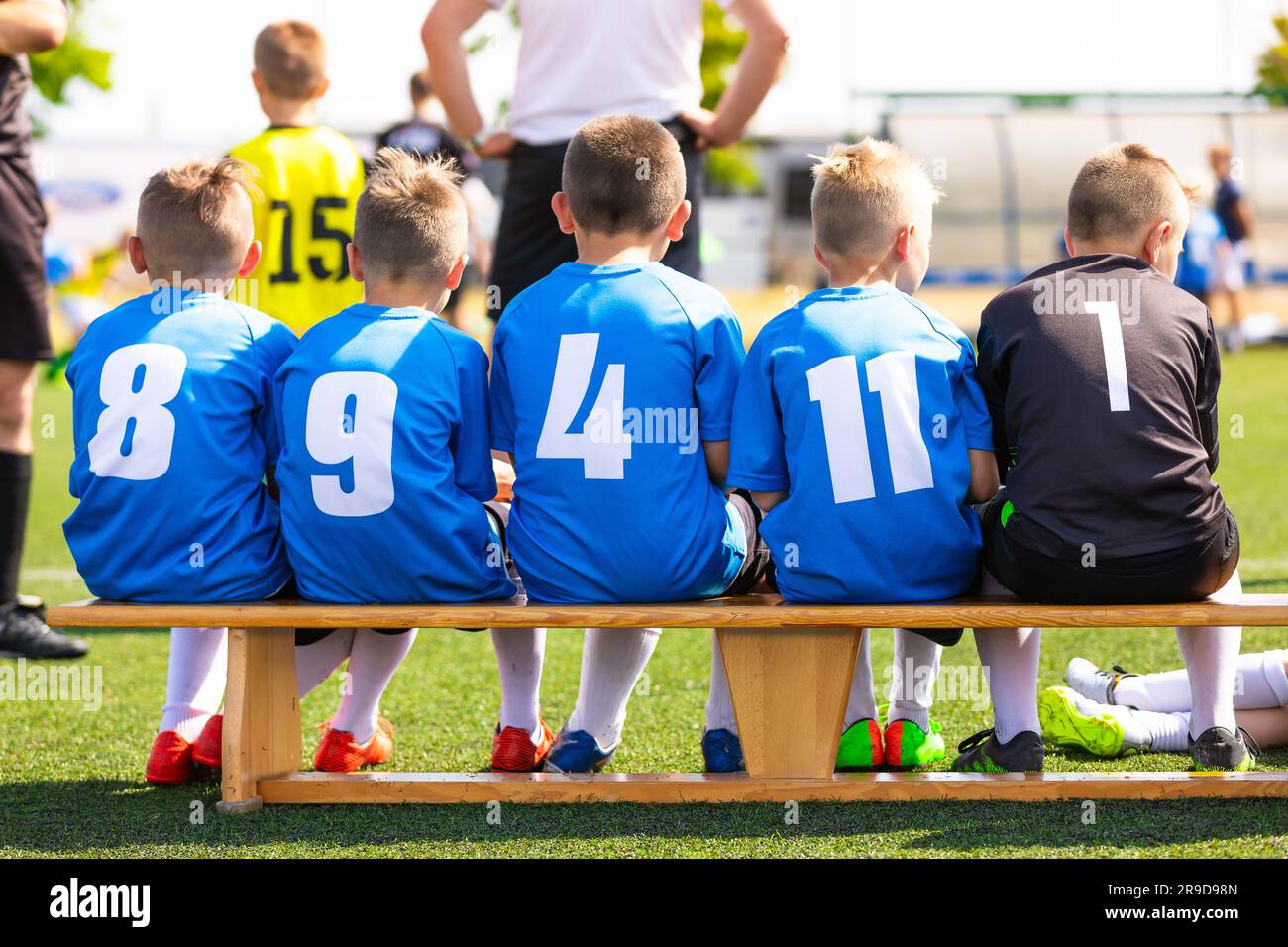 Soccer boys sitting on bench. Football players in youth team sitting on ...