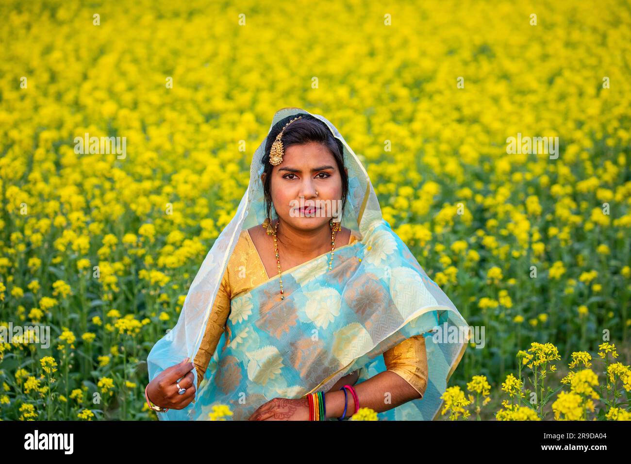 A rural Bangladeshi newly-wed woman inside a mustard field at Singair ...