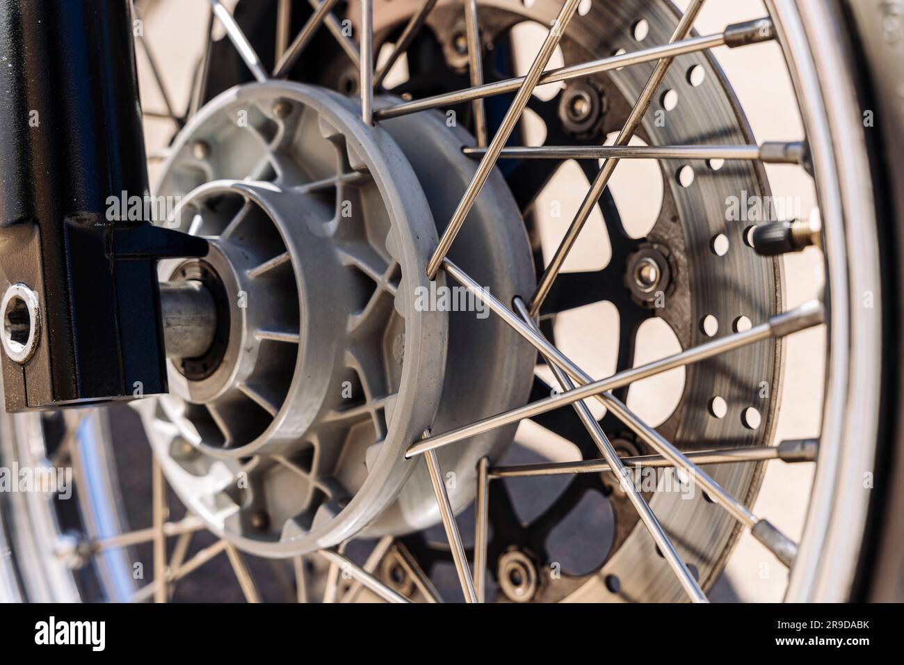 the front wheel of the motorcycle. the spokes of the wheel and the tire ...