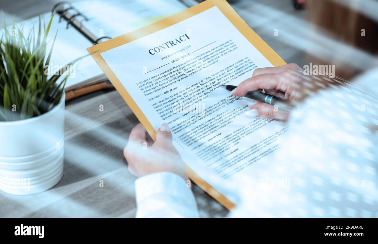 Female hands checking content of a contract; light effect Stock Photo ...